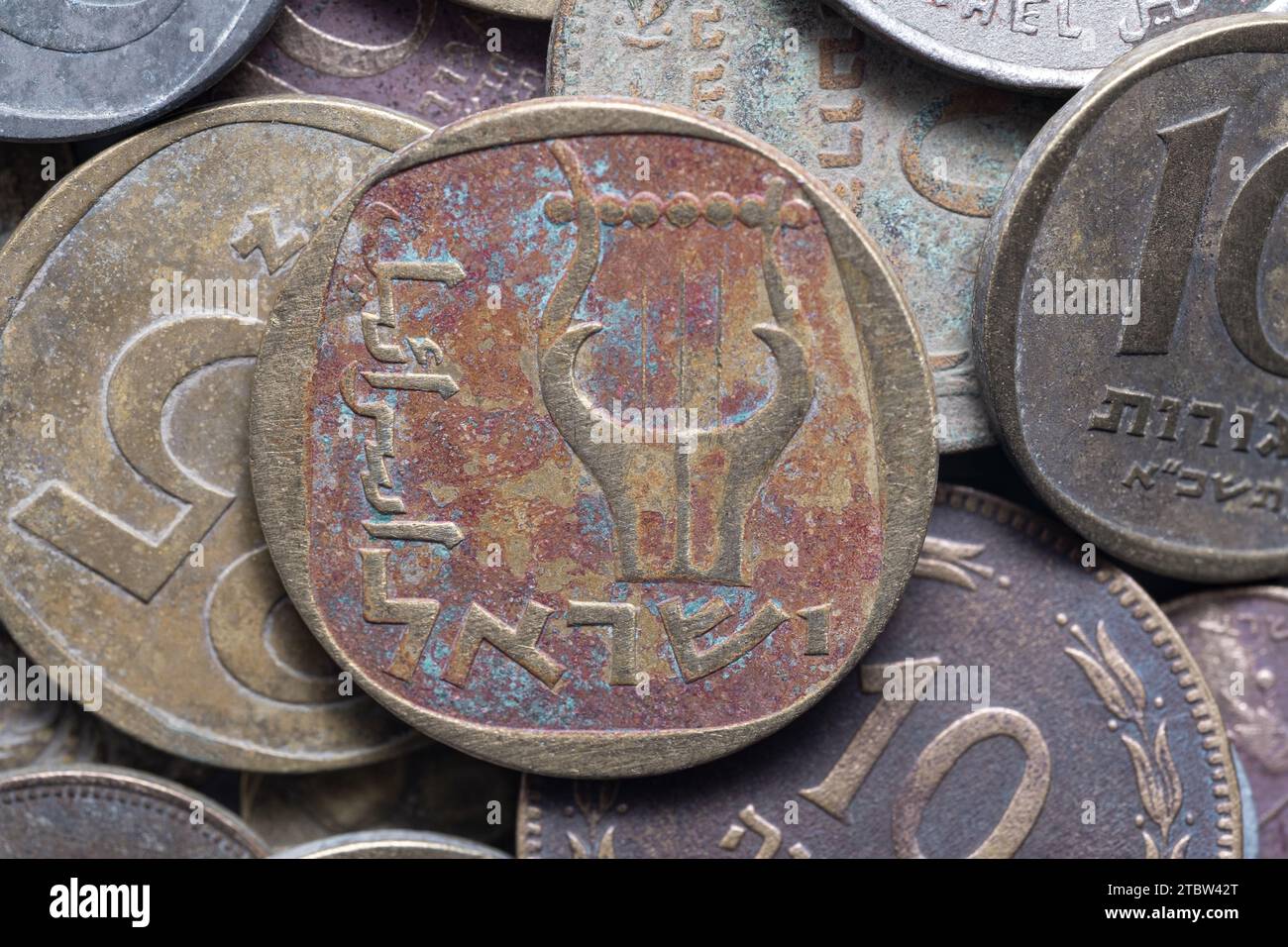 heap of old Israeli coins, including 25 agorot, reflects the historical ...