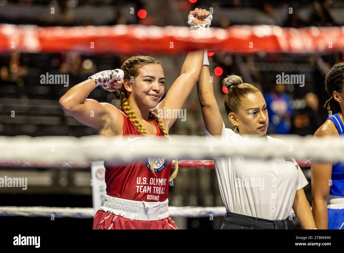 Kayla Gomez (red) has her hand raised by Referee Kathy Rivera during ...