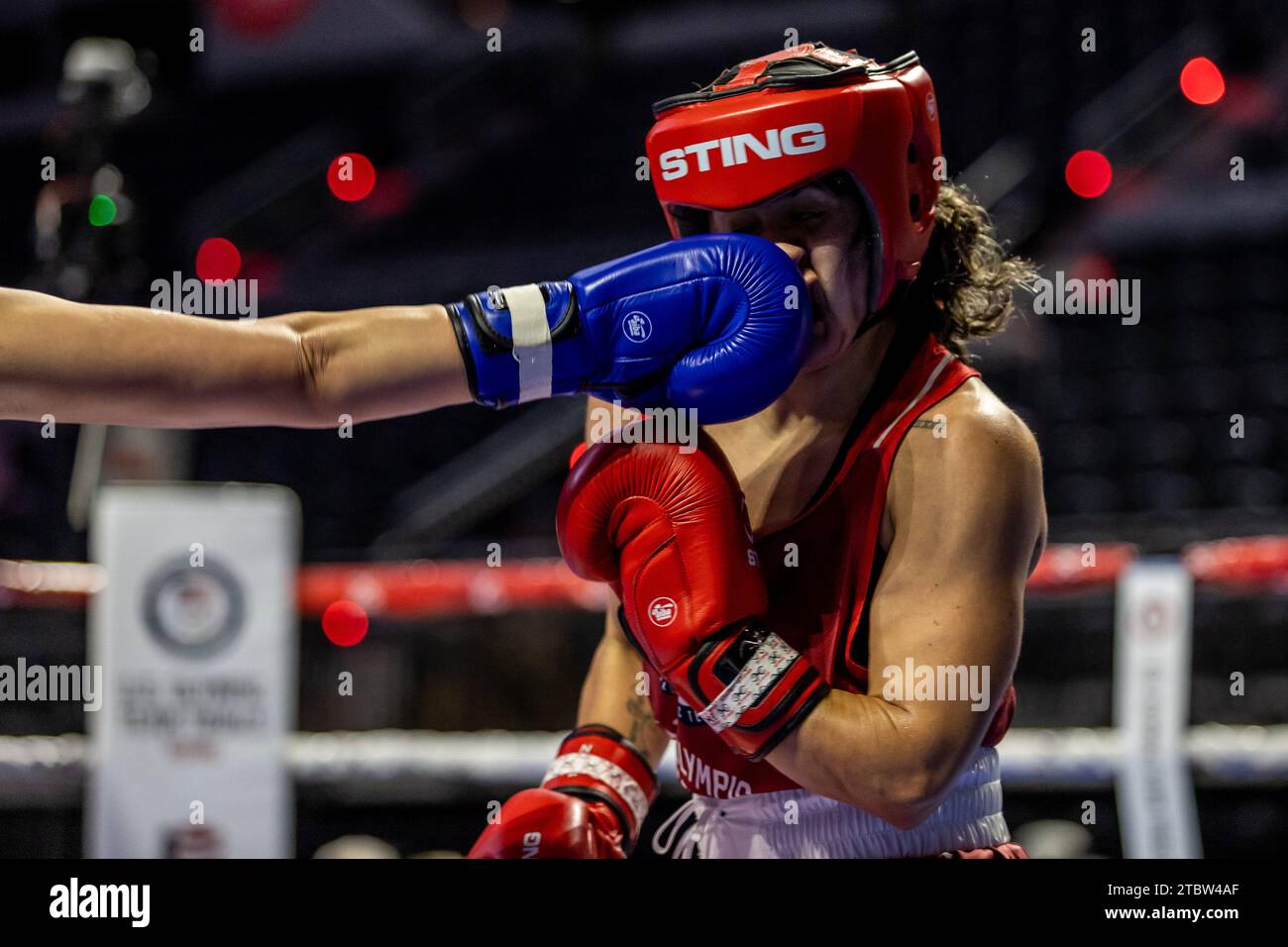 Nelda Ibarra (red) takes a jab from Emma Nayanet (blue) during the ...