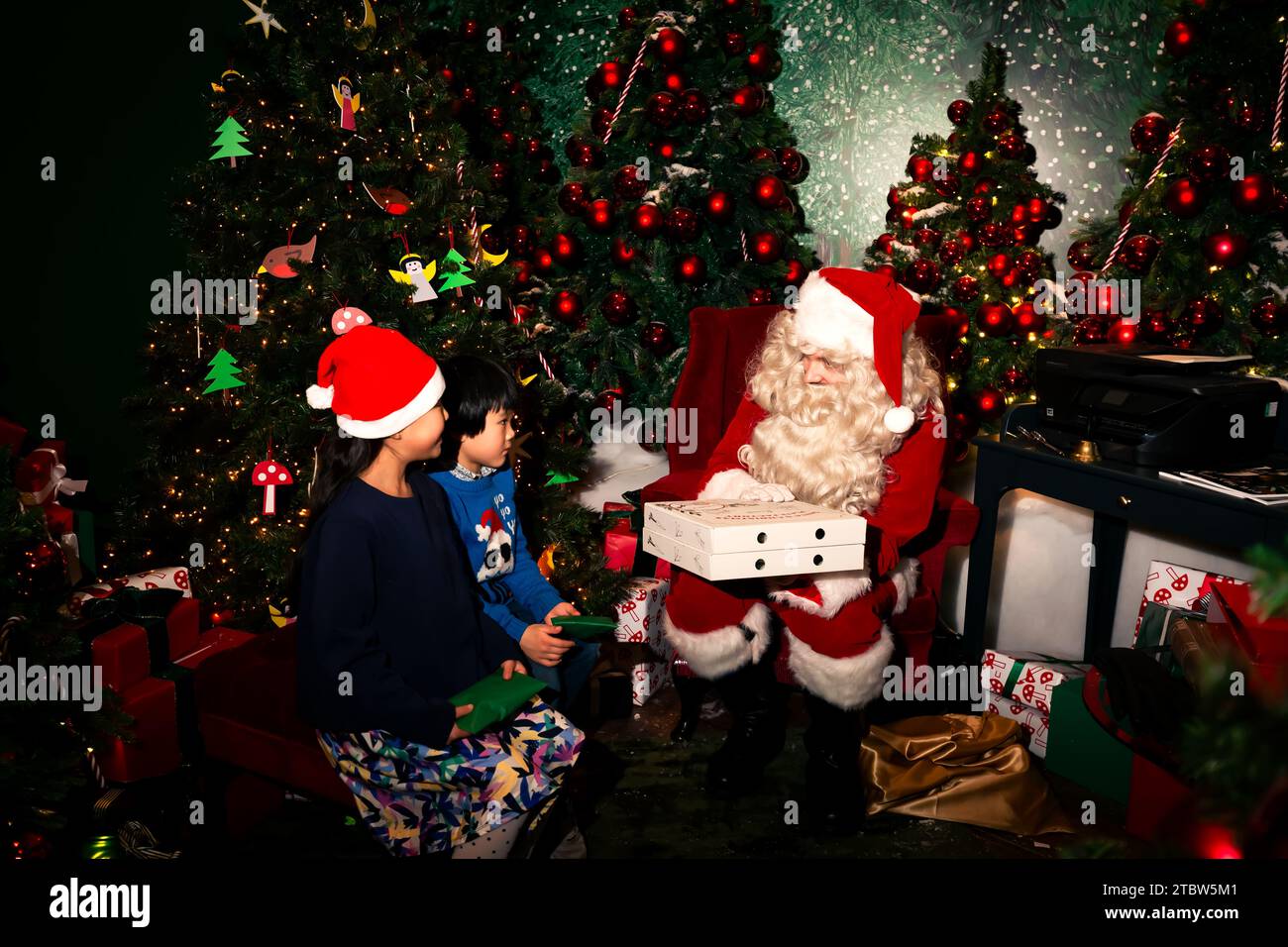 Santa is giving gifts to Children during Christmas time Stock Photo - Alamy
