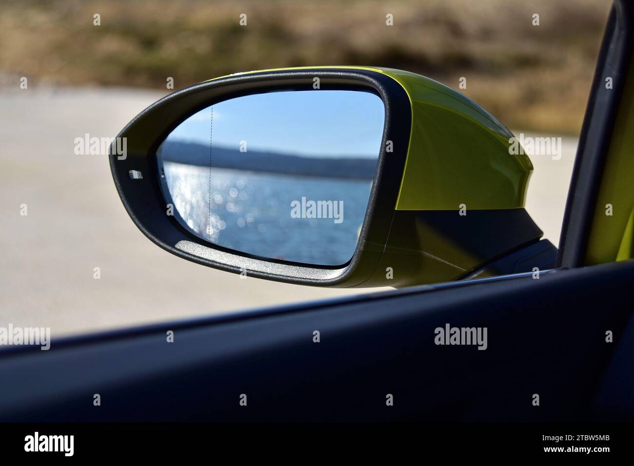 Side mirror of a passenger car with glare on the side window Stock ...