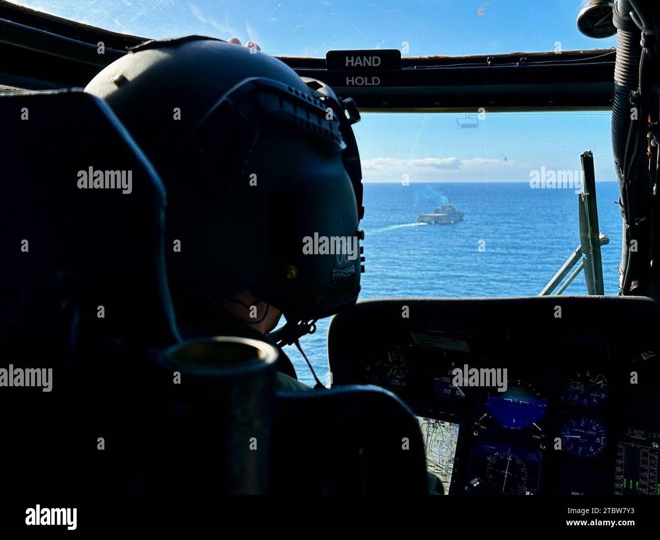 A 920th Rescue Wing HH-60G Pave Hawk helicopter flies toward USS ...