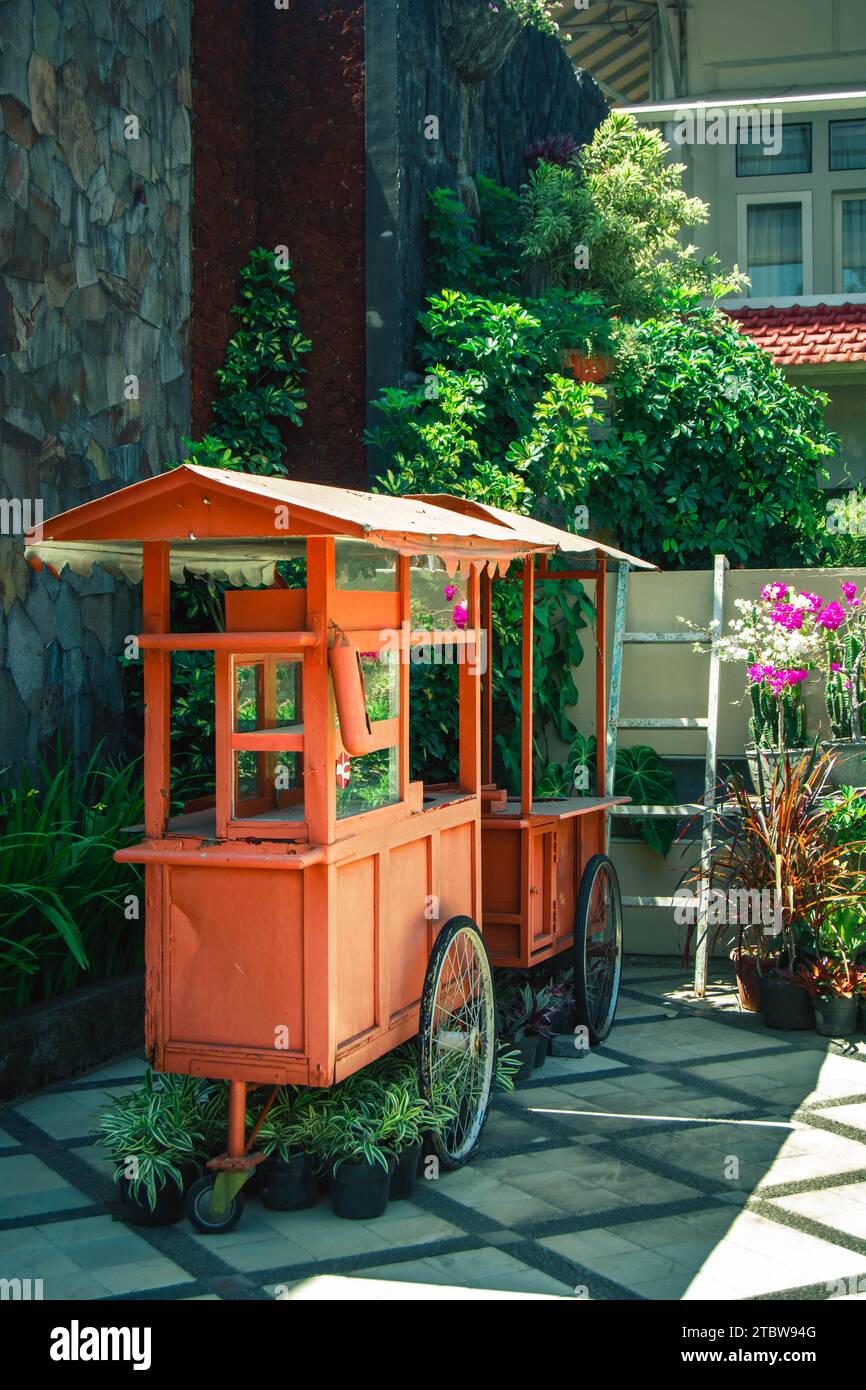 An Orange Food Cart That is No Longer Used and Thrown Away Behind a ...