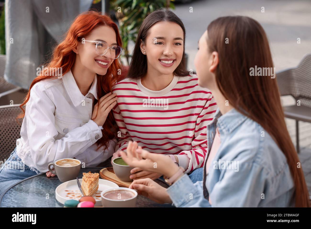 Happy friends spending time together in outdoor cafe Stock Photo - Alamy