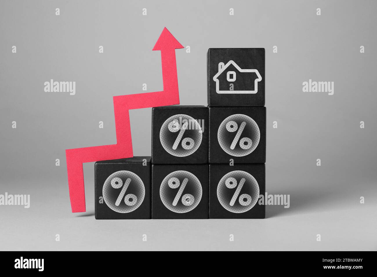 Mortgage rate rising illustrated by upward arrow, black cubes with ...