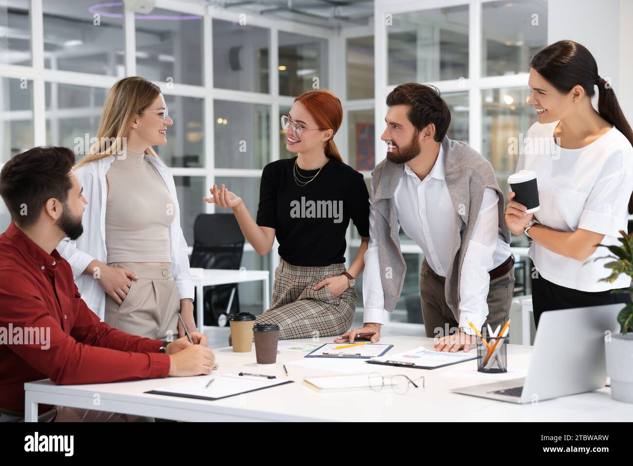 Team of employees working together in office Stock Photo - Alamy