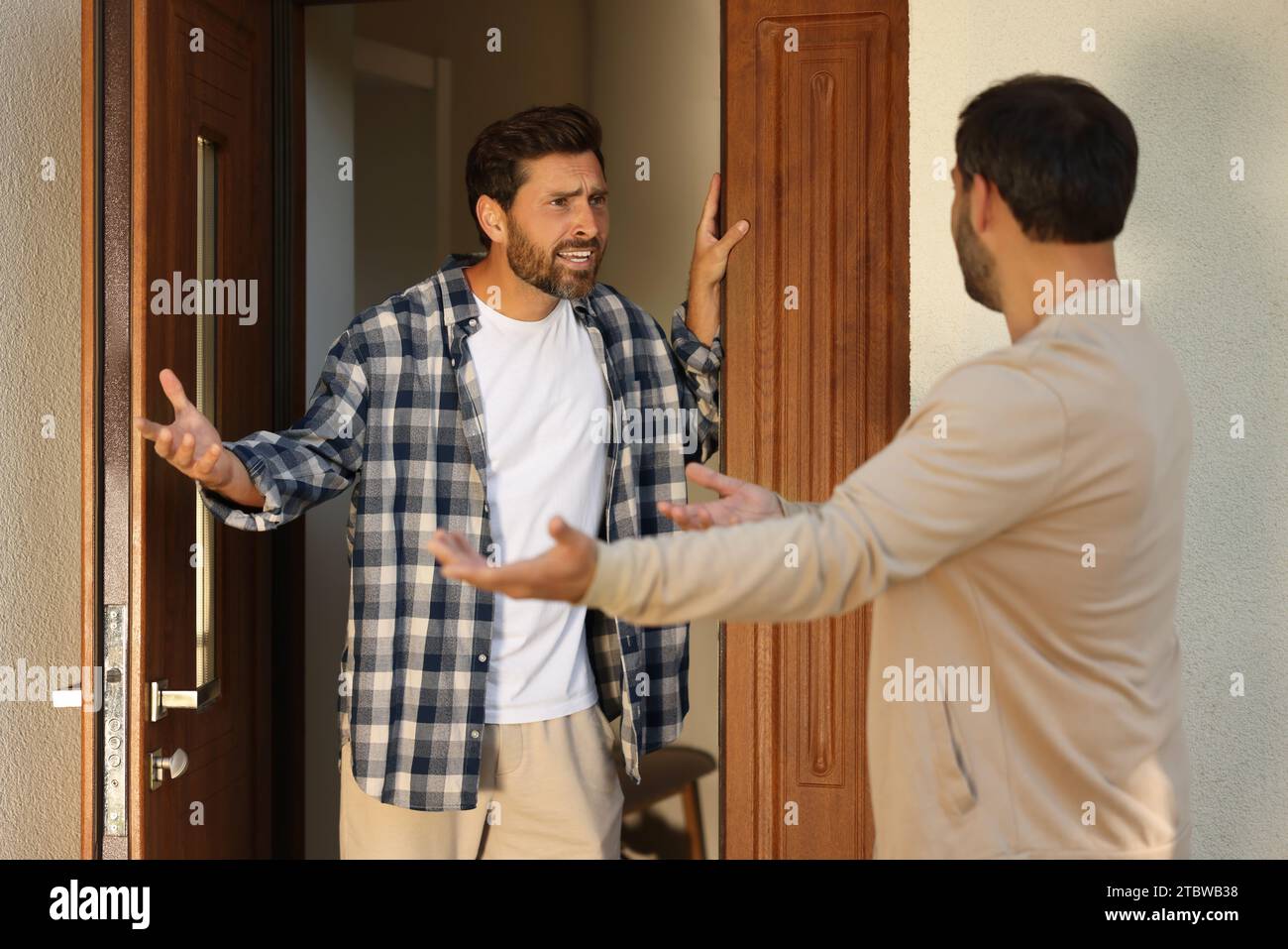 Emotional neighbours having argument near house outdoors Stock Photo ...