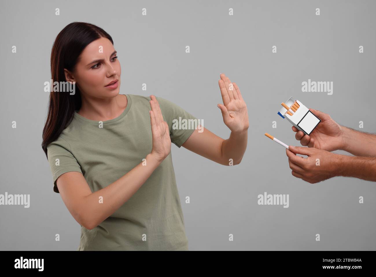 Stop smoking concept. Woman refusing cigarettes on grey background ...