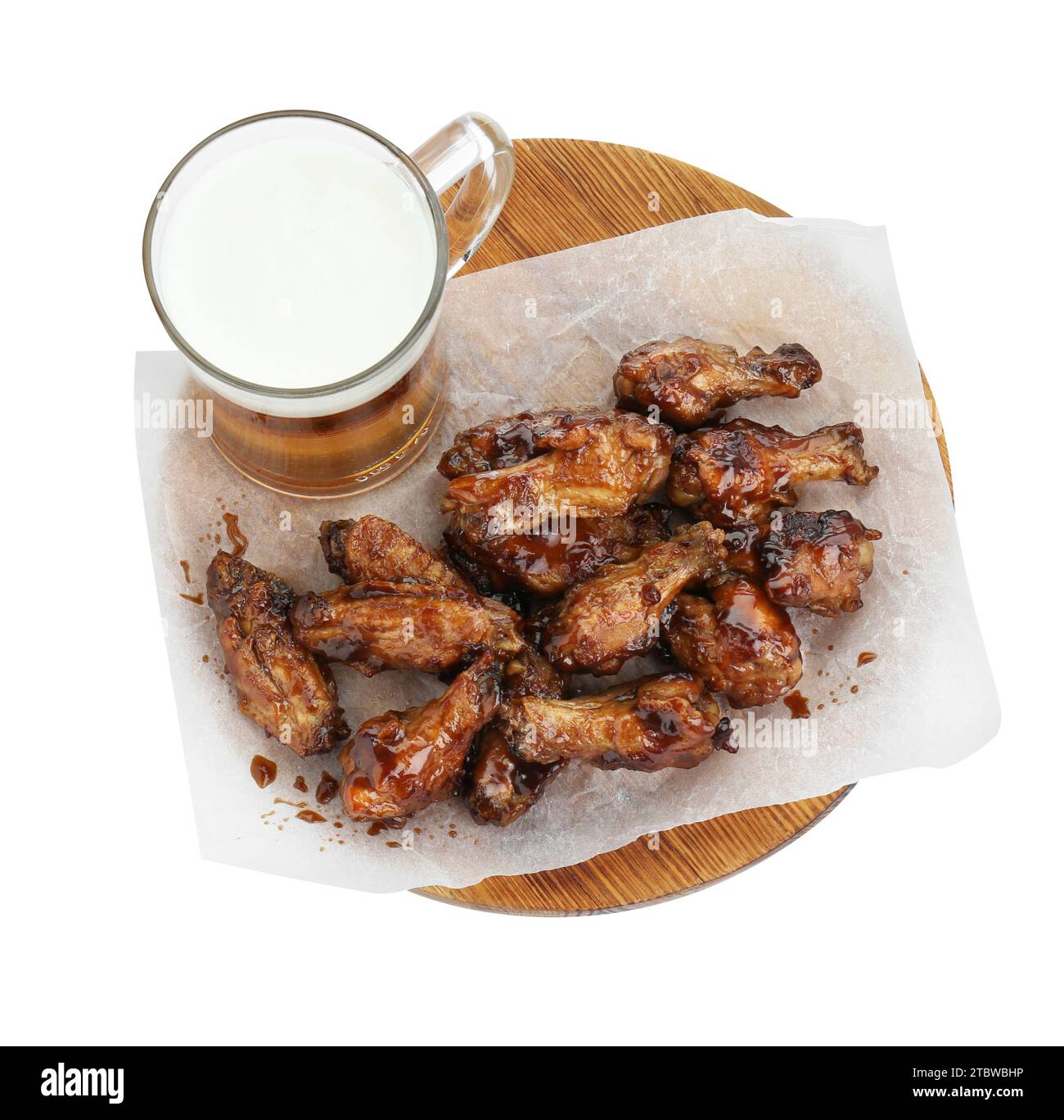 Tasty chicken wings and mug of beer isolated on white, top view ...