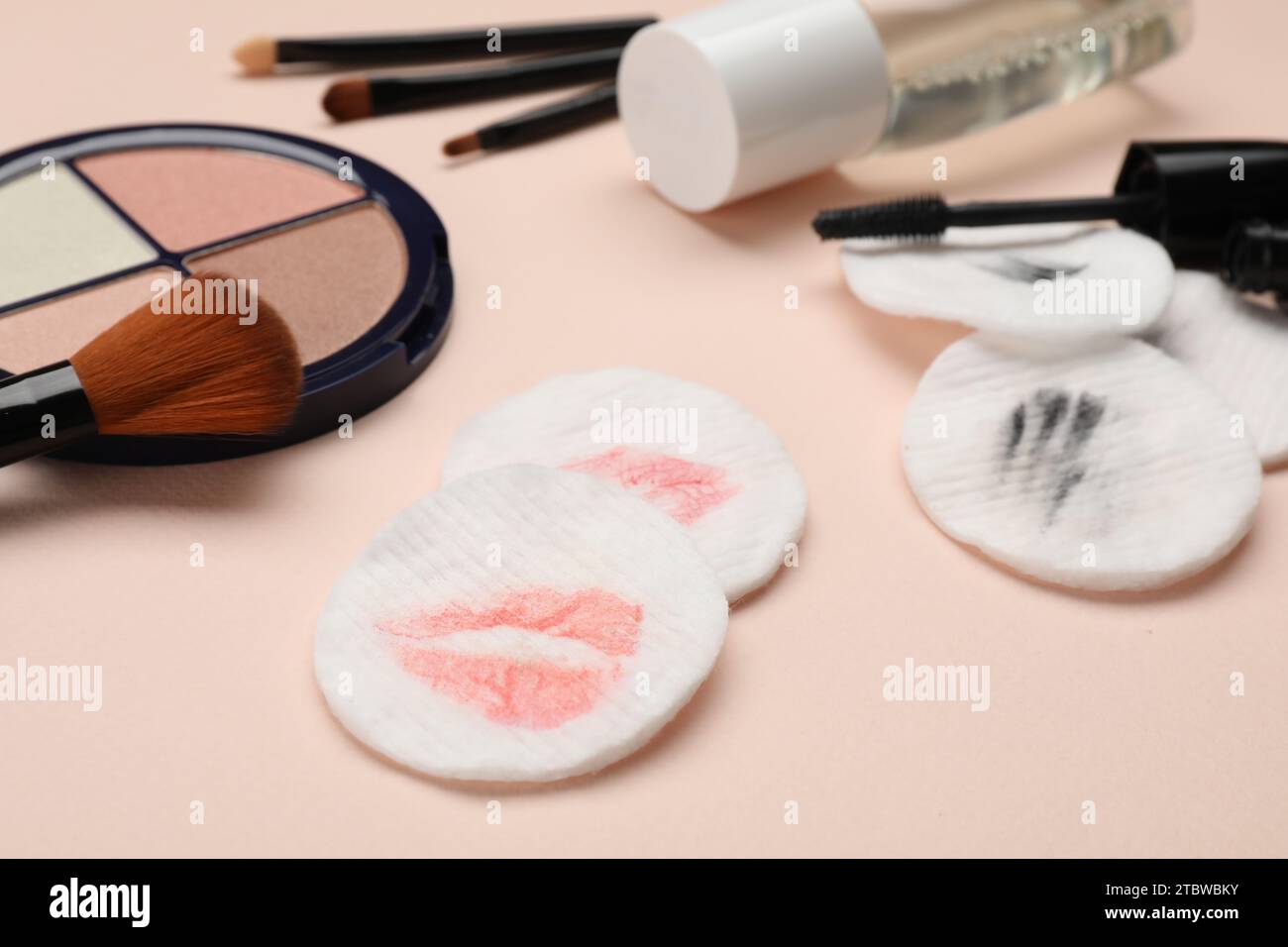 Dirty cotton pads after removing makeup and cosmetic products on beige ...