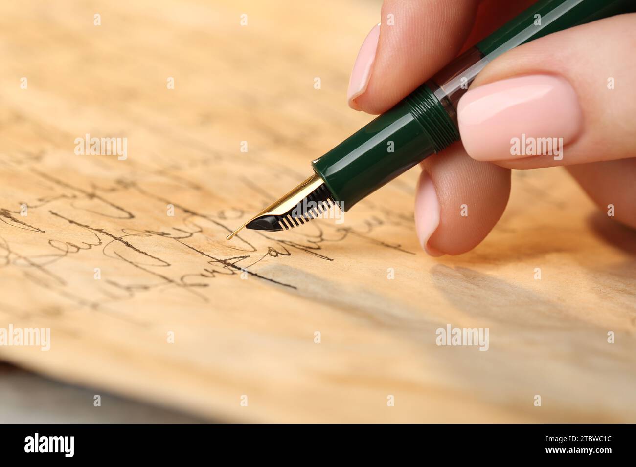 Woman writing letter with fountain pen, closeup Stock Photo - Alamy