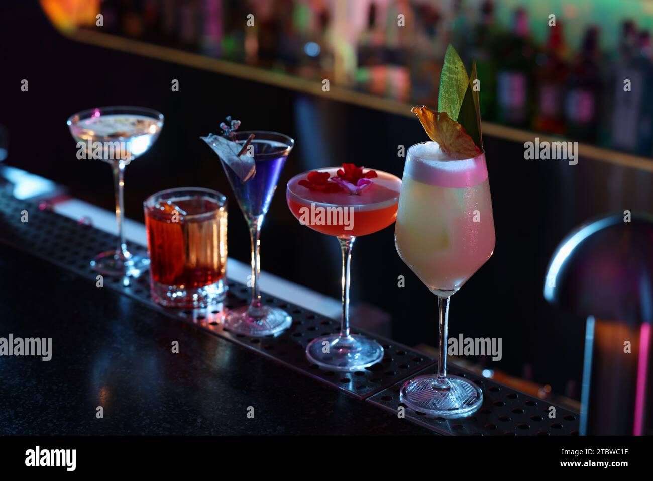 Different fresh alcoholic cocktails on counter in bar Stock Photo - Alamy