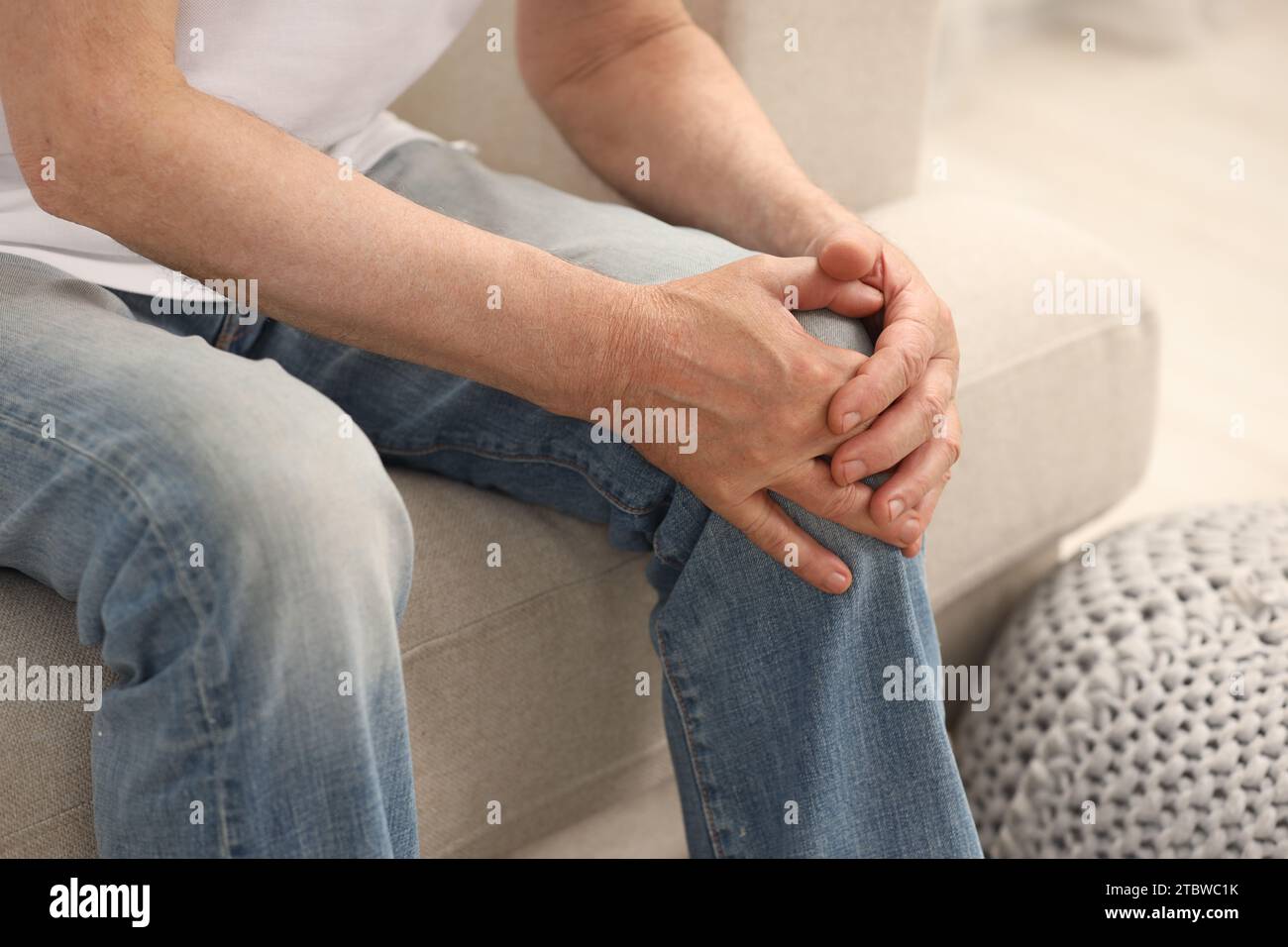 Senior man suffering from pain in leg indoors, closeup. Rheumatism ...
