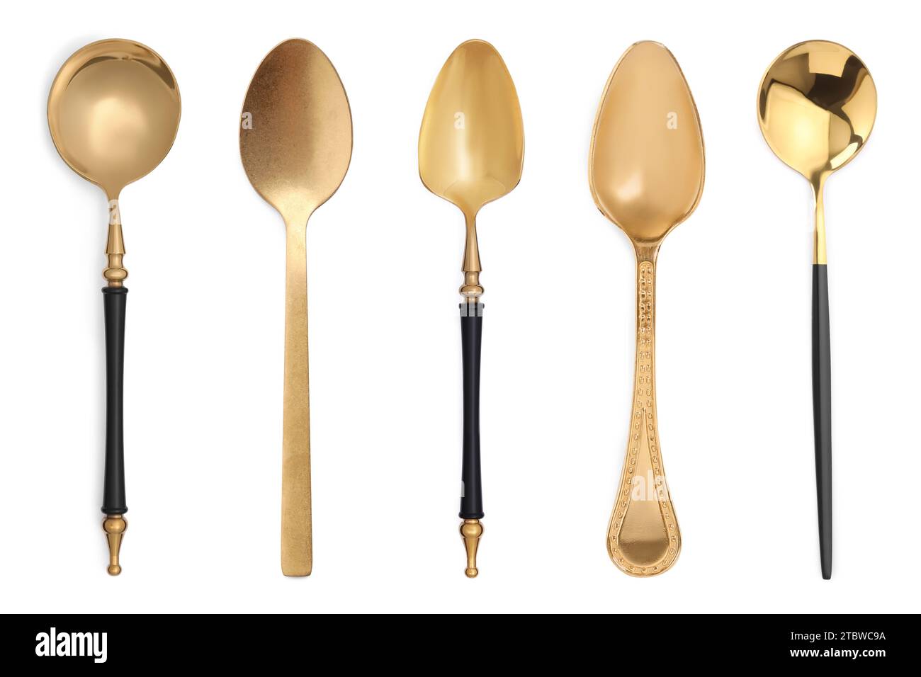 Different stylish golden spoons on white background Stock Photo - Alamy