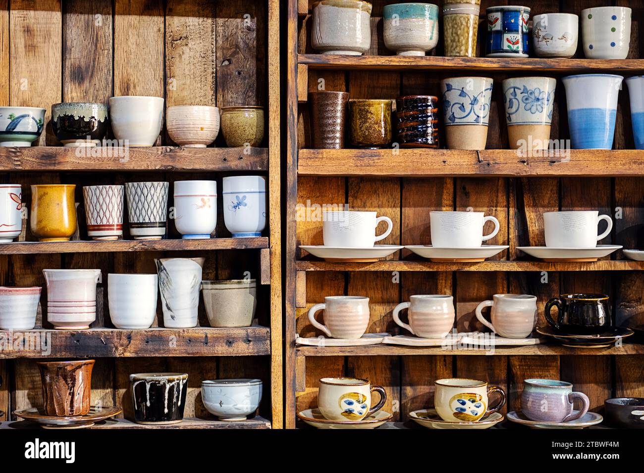 Various pottery ceramic displayed on wooden shelves at store Stock ...
