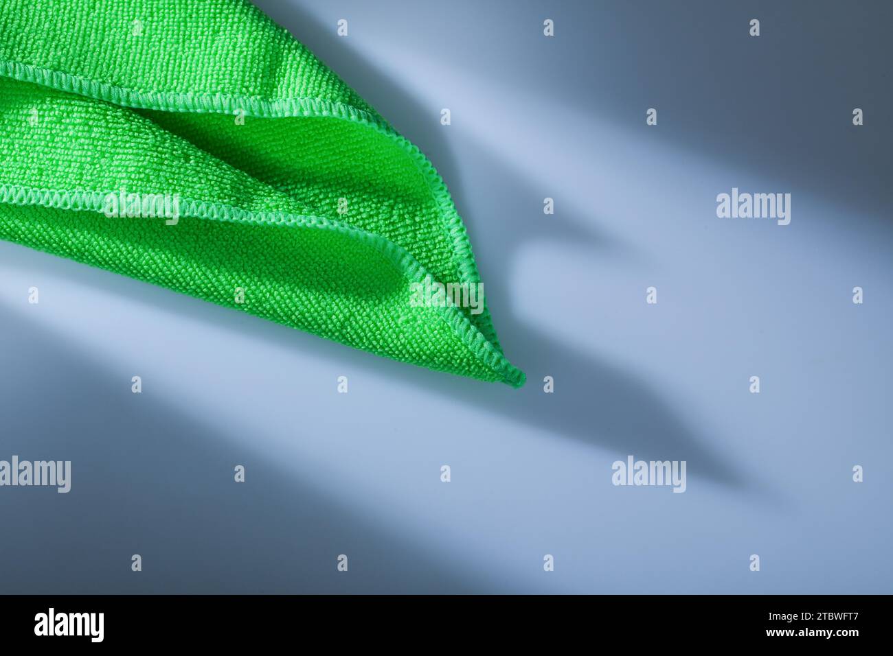 Green kitchen dishwashing cloth on white surface Stock Photo - Alamy