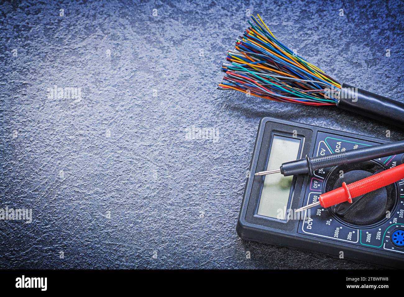 Digital multimeter electric tester wires on black background ...