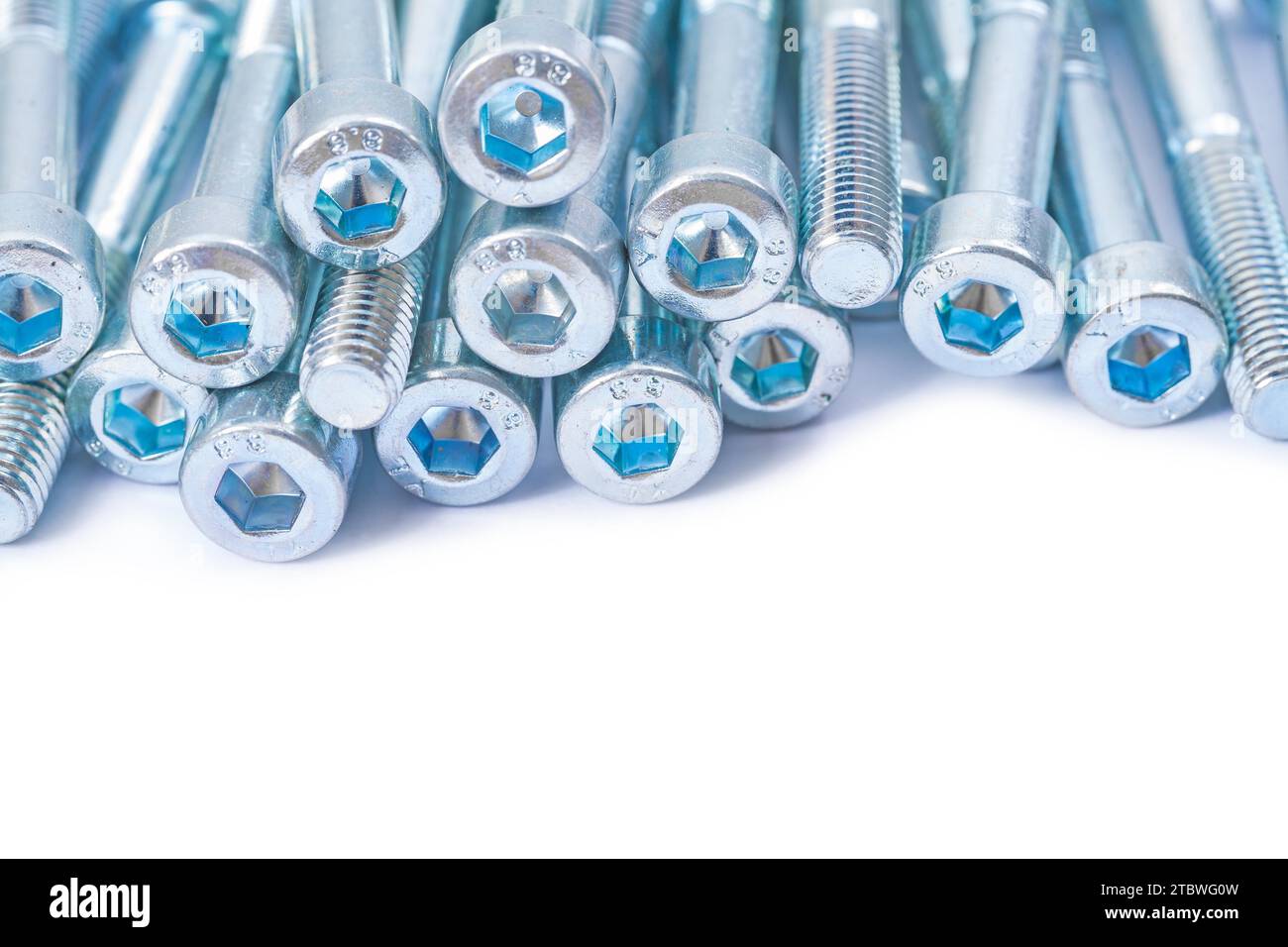 Industrial background stack of bolts isolated Stock Photo - Alamy