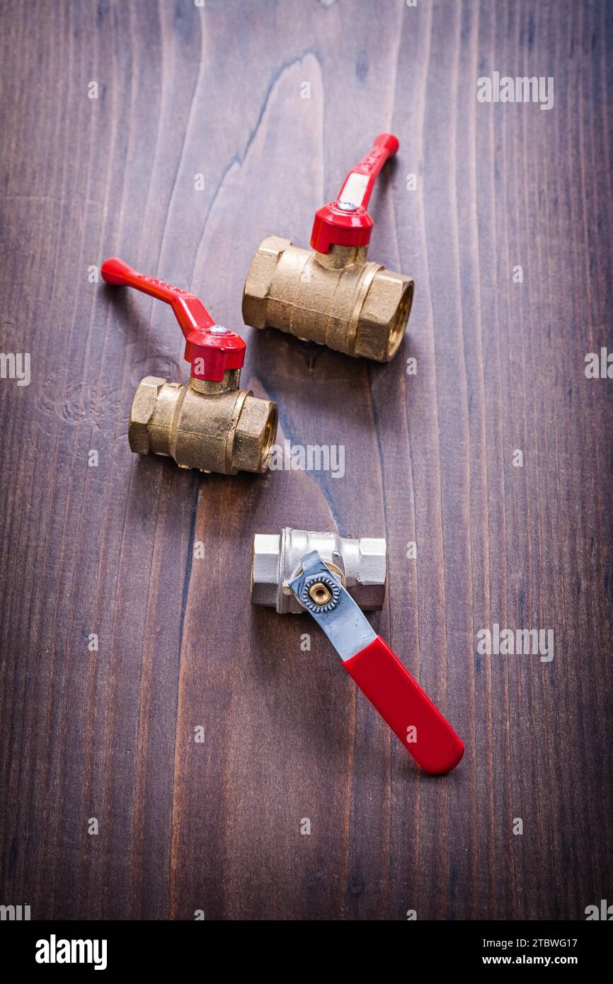 Three plumbers fixtures on vintage wooden board Stock Photo - Alamy