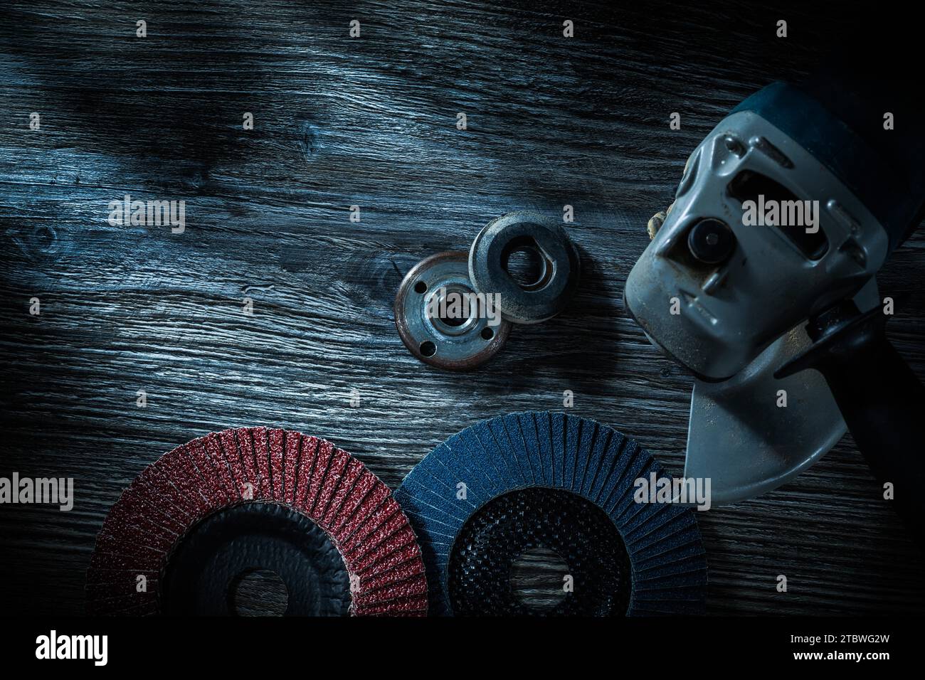 Hand angle grinder rotary sanding discs on vintage wooden board Stock ...