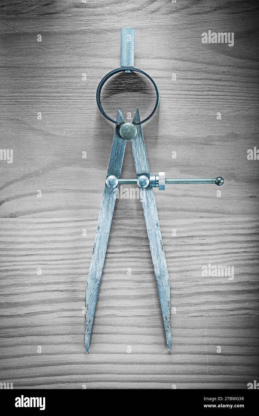 Pair of compasses on wooden board construction concept Stock Photo - Alamy