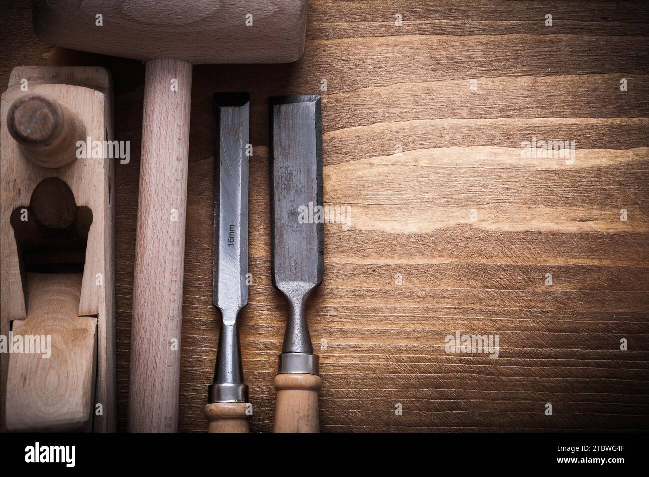 Wooden hammer shaving plane flat chisels on wood board construction ...