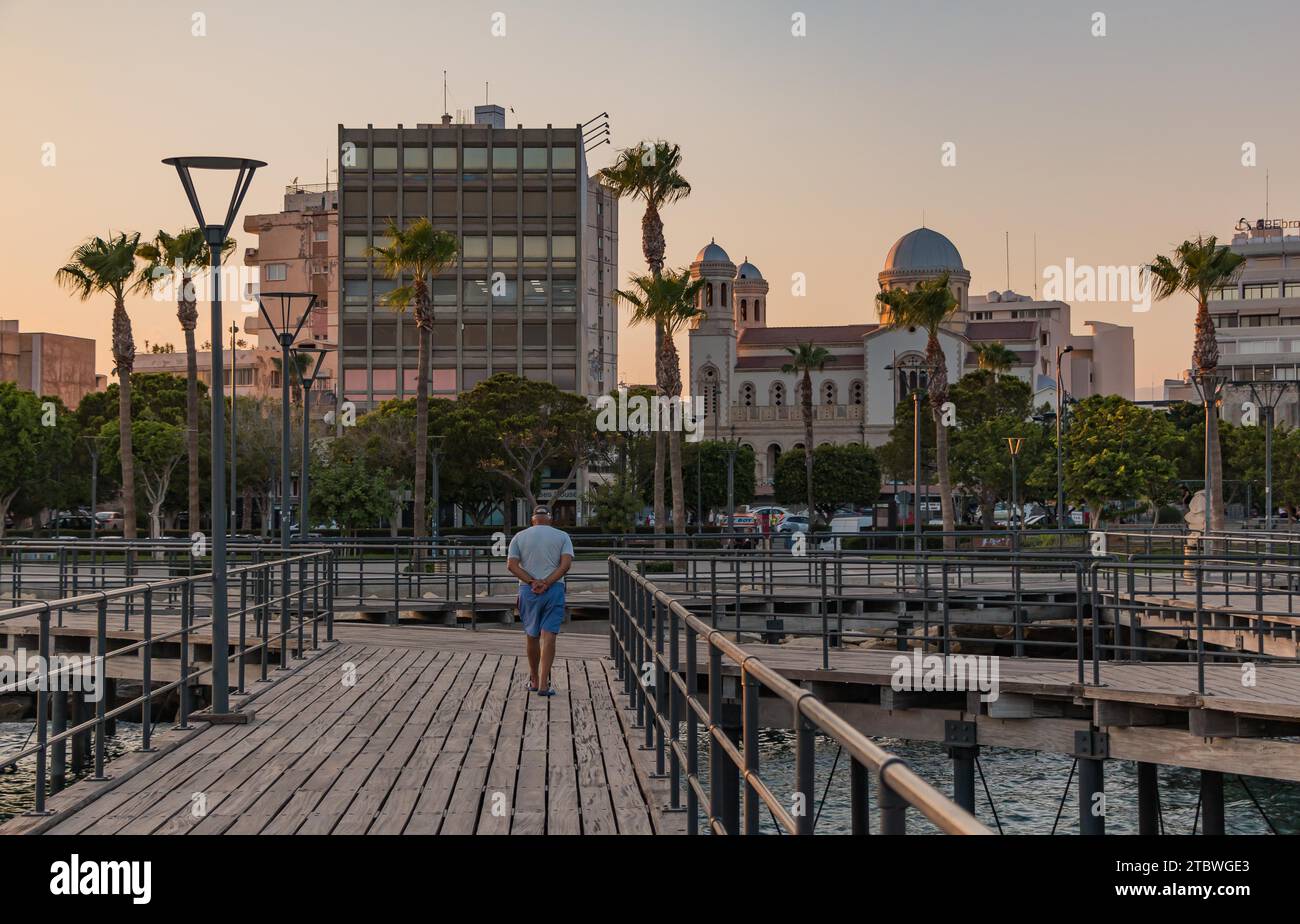 A picture of a man walking in a pier in the grand promenade of Limassol ...