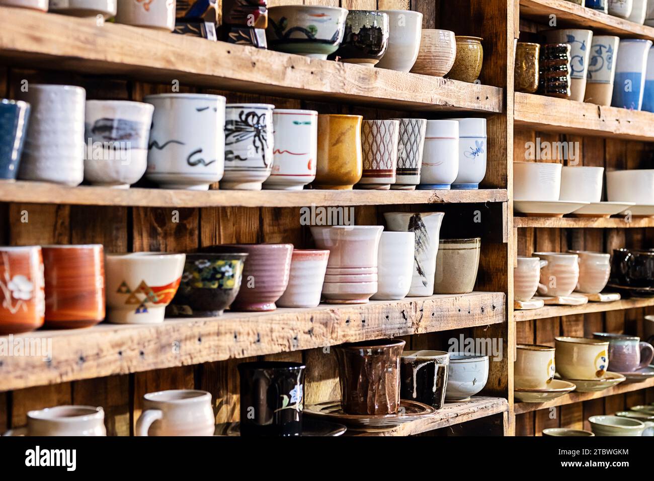 Various pottery ceramic displayed on wooden shelves at store Stock ...