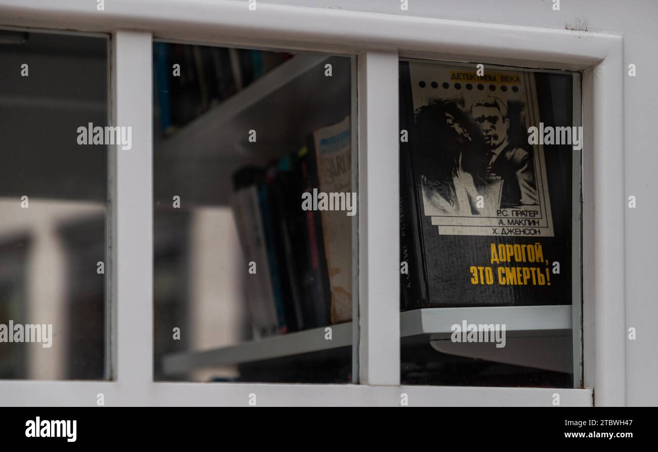 A picture of a group of books sitting on a shelf inside a phone booth ...