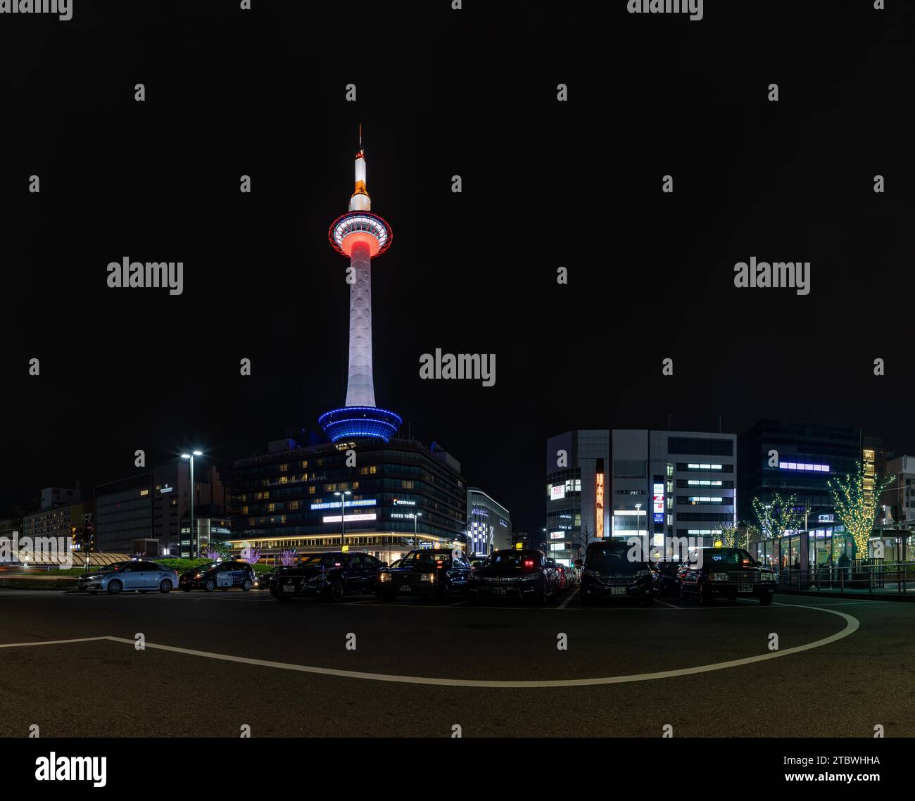 A panorama picture of the Kyoto Tower and the Tokyo Station square at night Stock Photo - Alamy