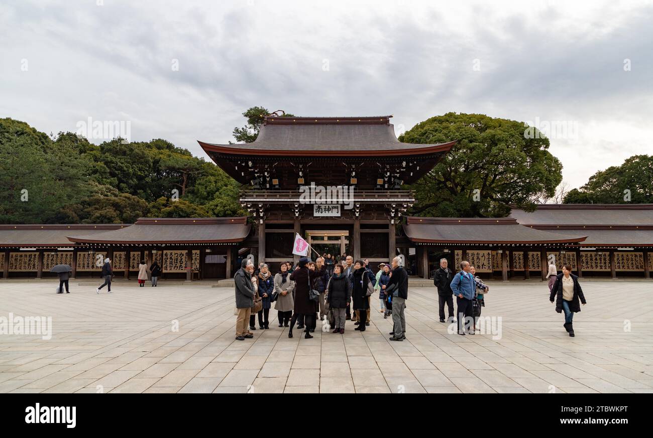 A picture of a tour group inside the main square of the Meiji Jingu ...