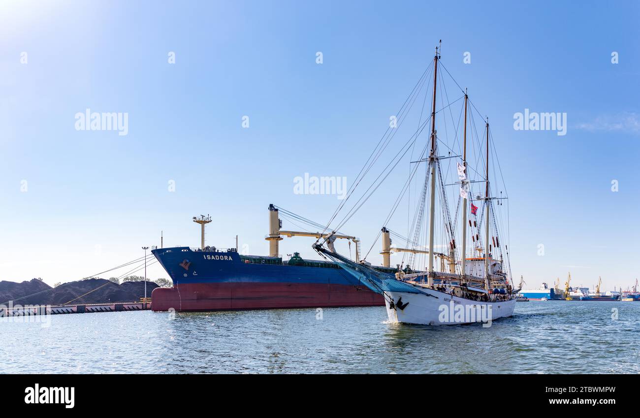 A picture of a sailing vessel in front of a bulk carrier in the Gdansk ...