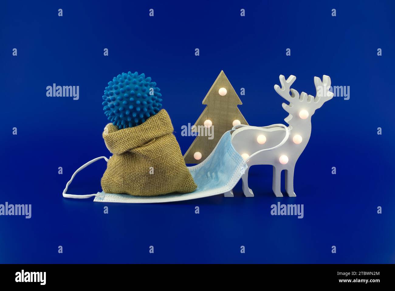 Christmas deer scene with coronavirus gift in sack bag on the sleigh ...