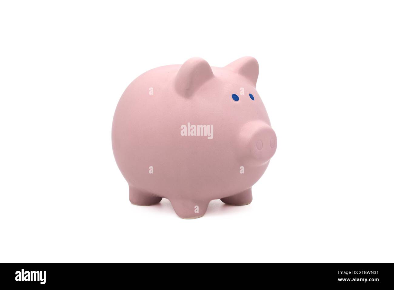 Side view of a pink ceramic piggy bank with blue eyes on a white ...