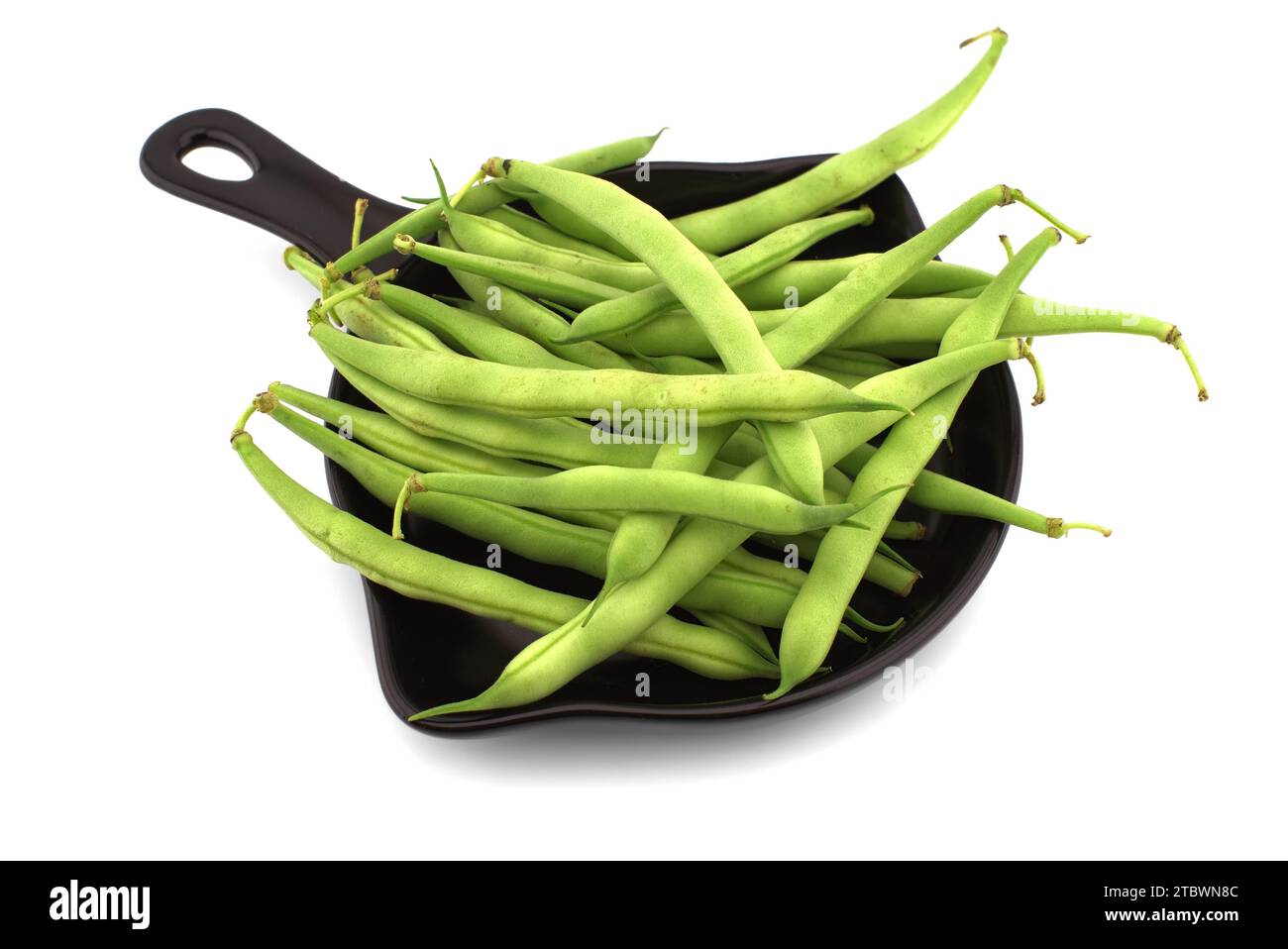 A handful of green beans in the cooking pan isolated on white ...