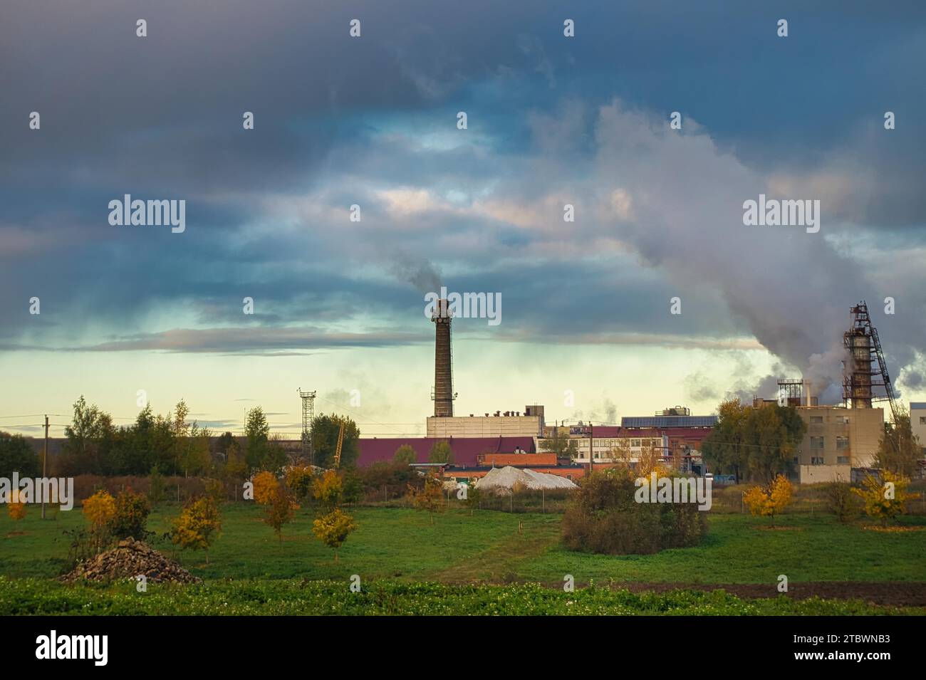 Smoke billowing from industrial smokestacks at a factory or plant at ...