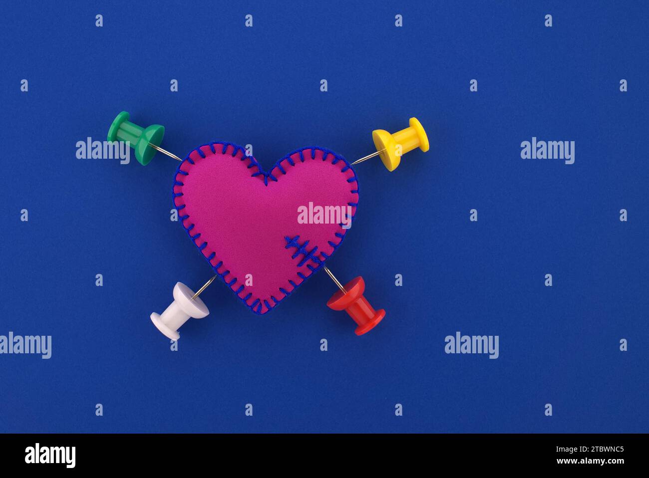 Heart pain, medical concept with multi color push pins stuck into a ...