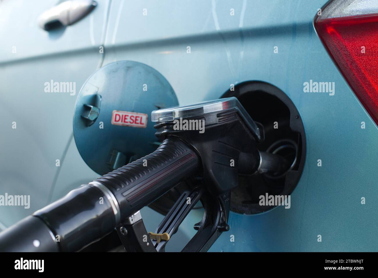 Refueling the car at a gas station fuel pump, open cap of a fuel tank ...