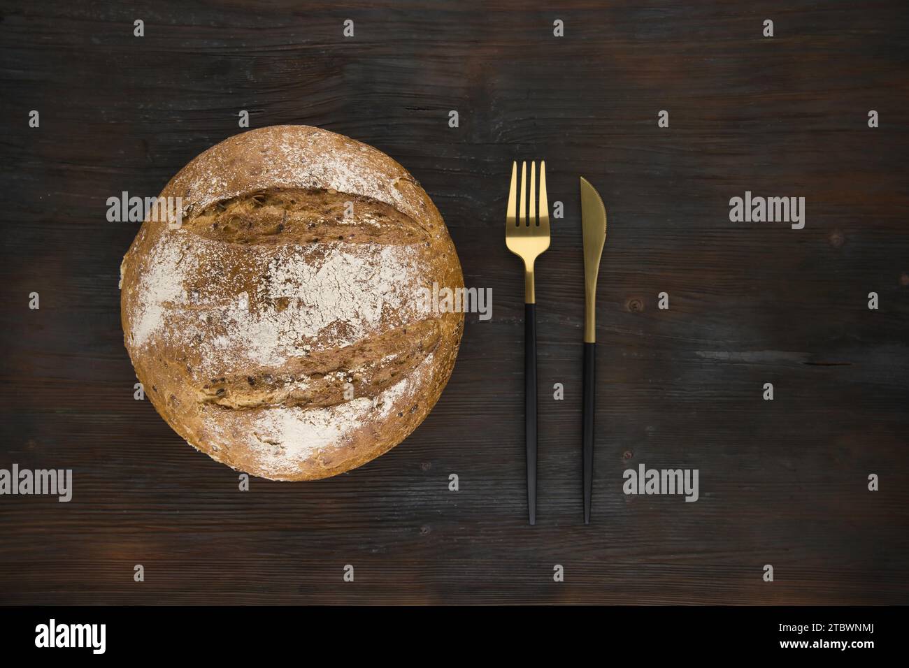 Bread loaf viewed from above. Bread over a wood background with golden ...
