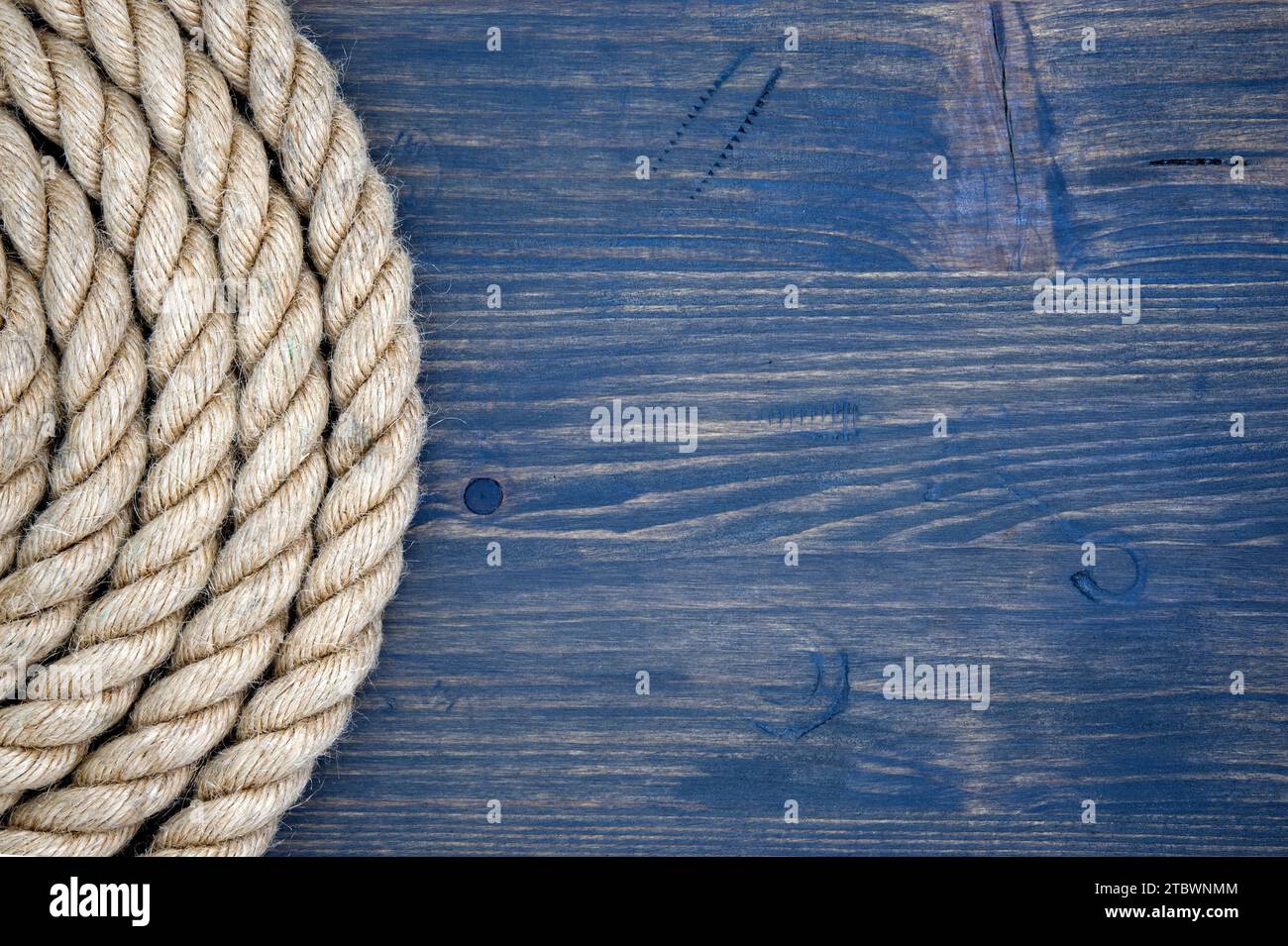 Braided natural jute rope over a rustic wood background with copy space ...