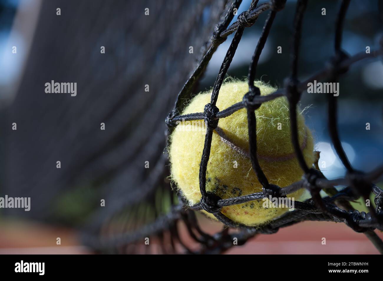 Tennis ball in the net. Ball hitting the tennis net, tennis scene with ...