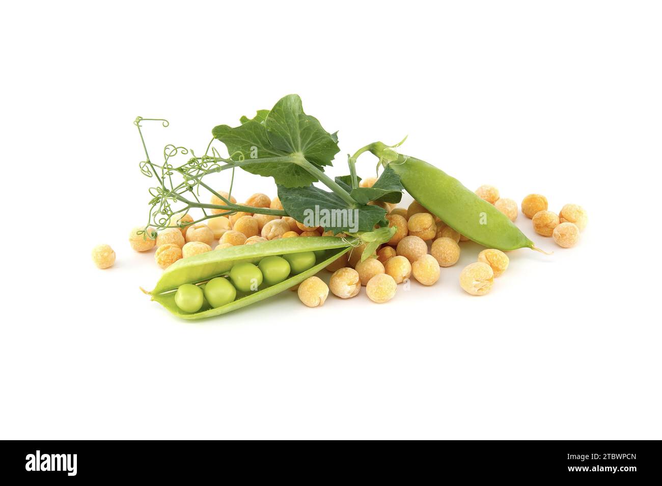 Dry whole yellow peas and sweet green peas with green leaves on white ...