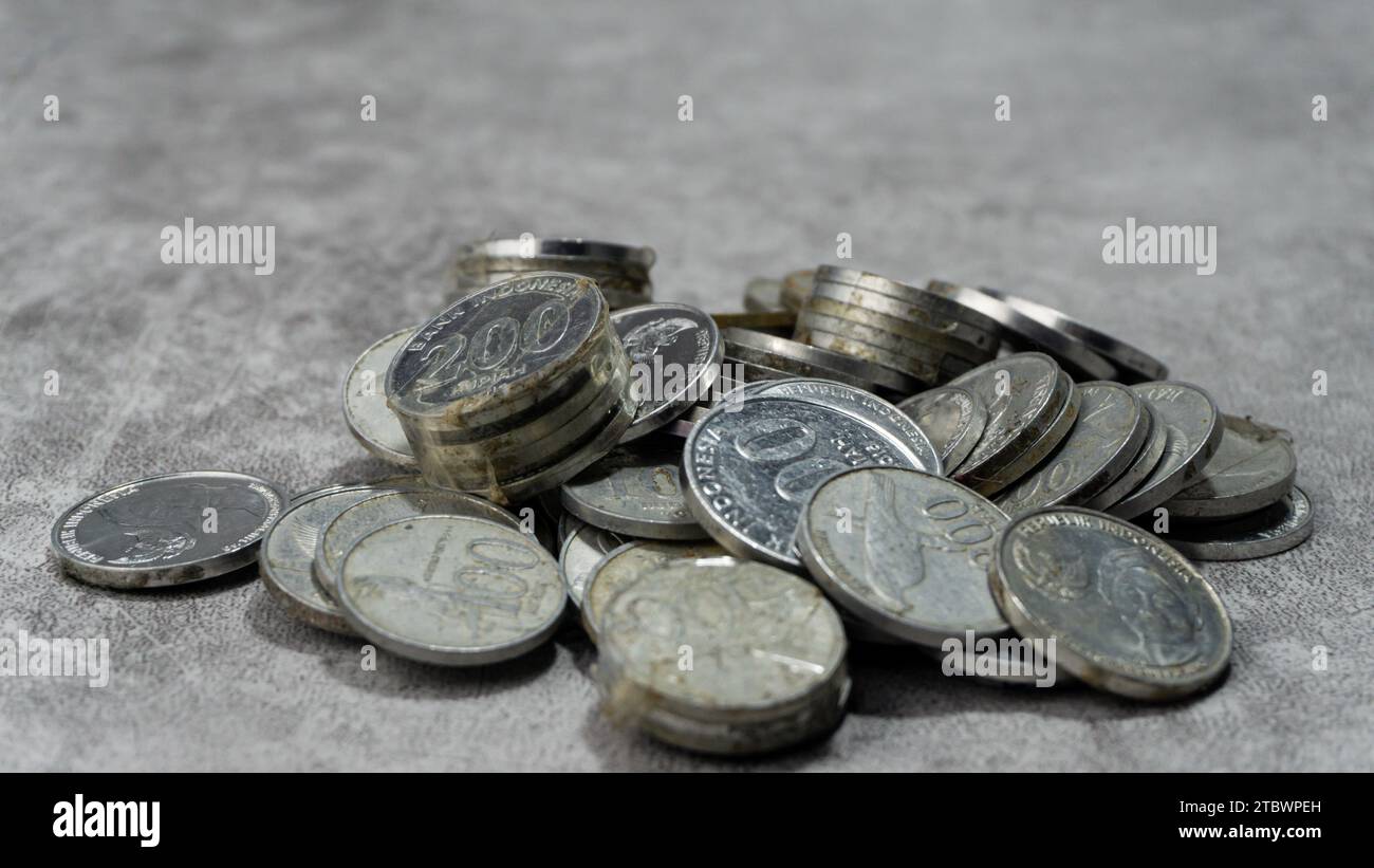 Stack of Indonesian Rupiah currency coins on a gray background with ...