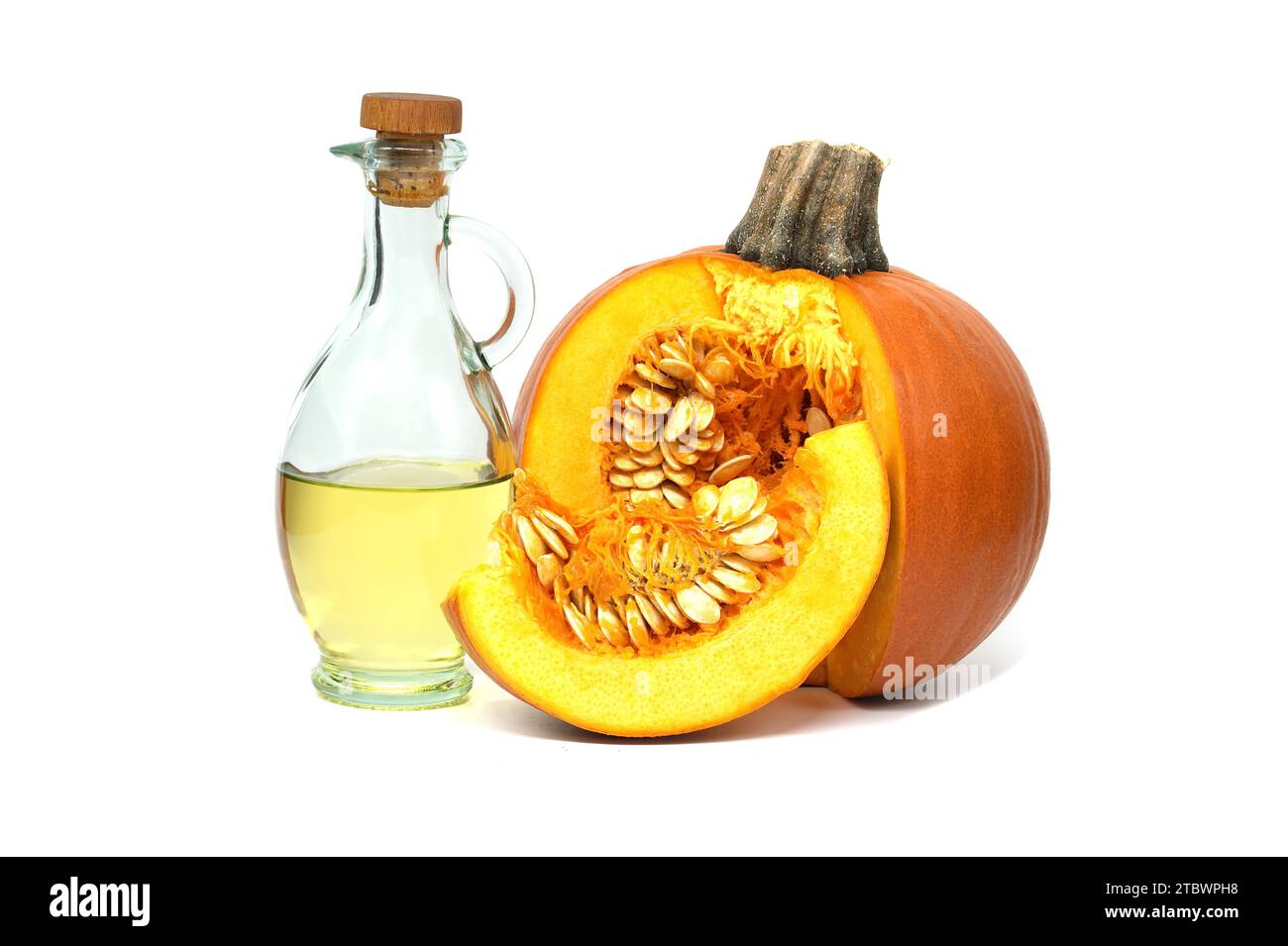 Pumpkin oil in glass decanter and fresh pumpkin with seeds isolated on ...
