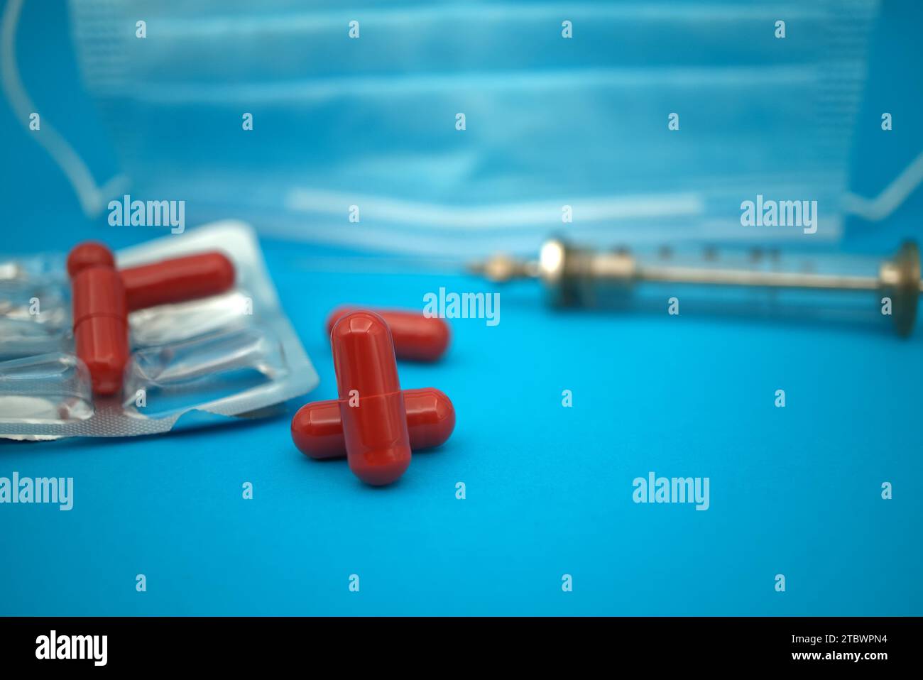 Medical, Covid-19 and healthcare background with red capsules scattered ...