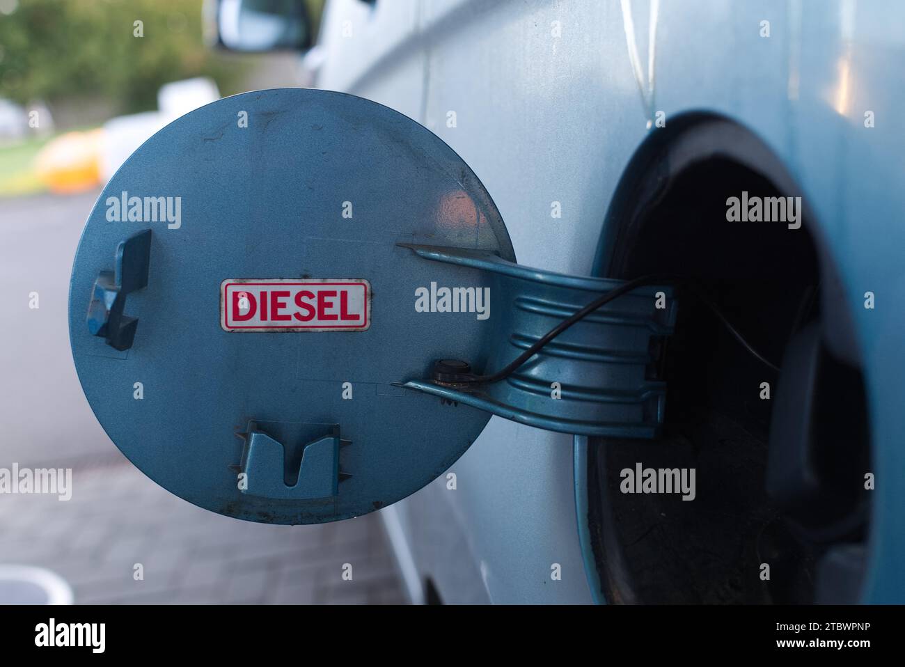 Close up on the open cap of a fuel tank of a vehicle with red sign for ...