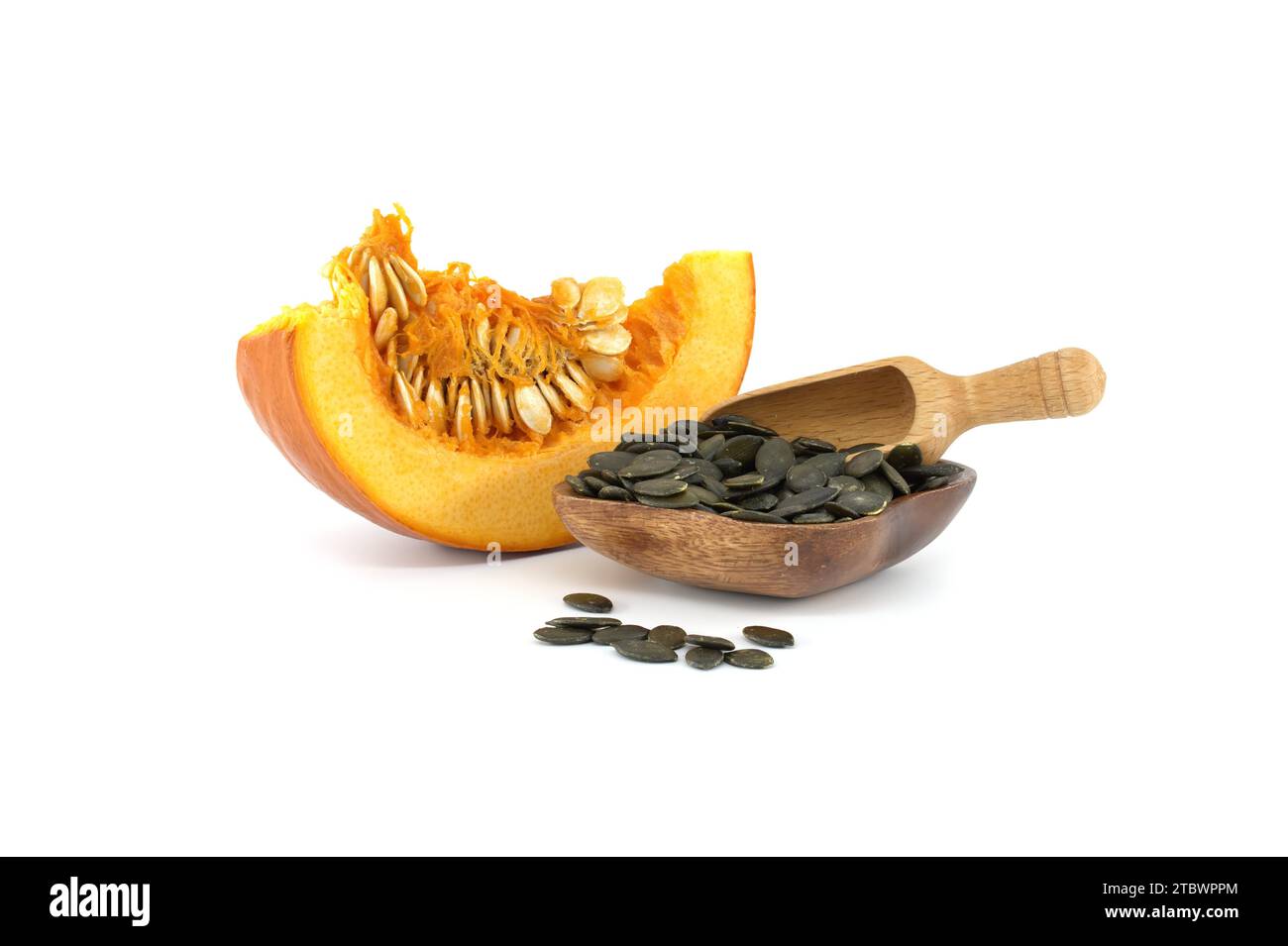Dried hulled pumpkin seeds or pepitas in wooden bowl and fresh pumpkin ...