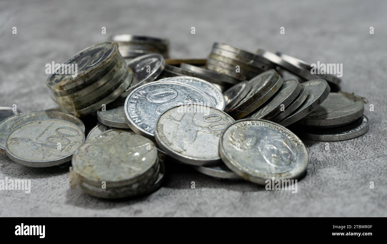 Stack of Indonesian Rupiah currency coins on a gray background with ...