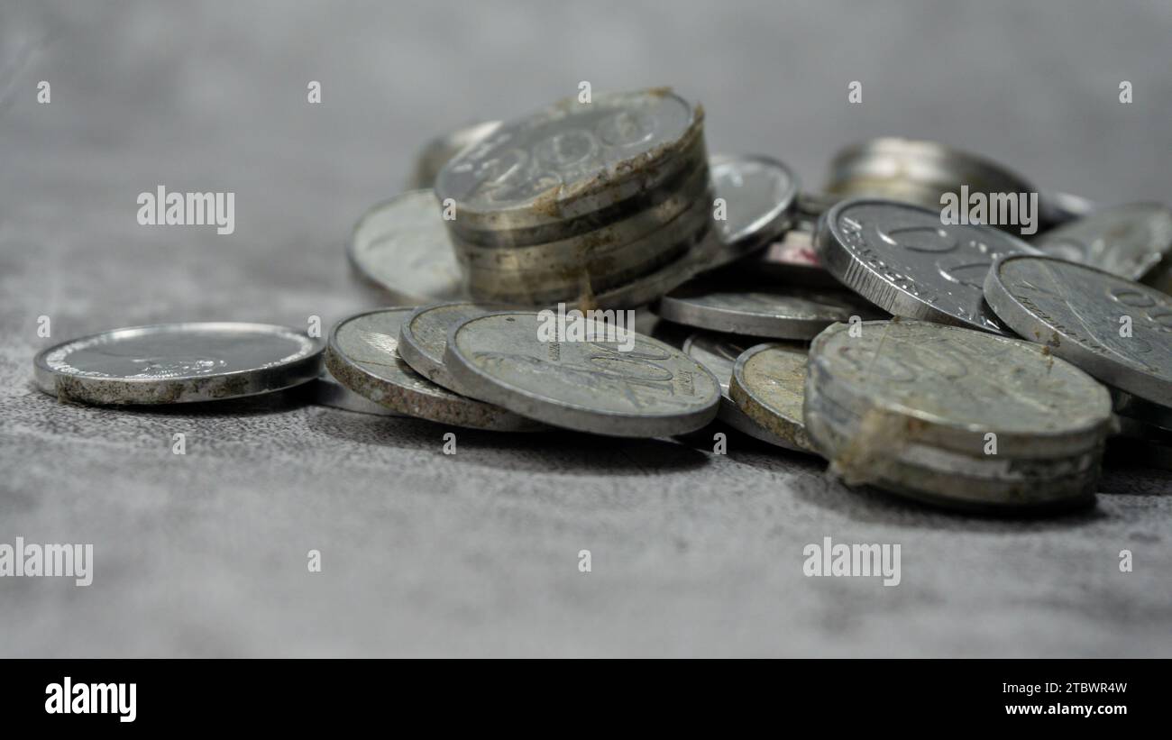 Stack of Indonesian Rupiah currency coins on a gray background with ...