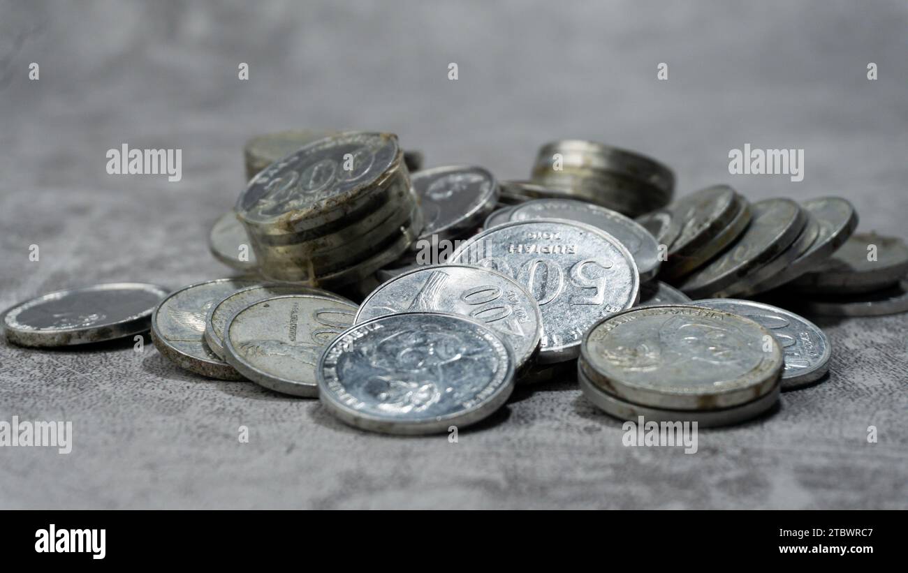 Stack of Indonesian Rupiah currency coins on a gray background with ...